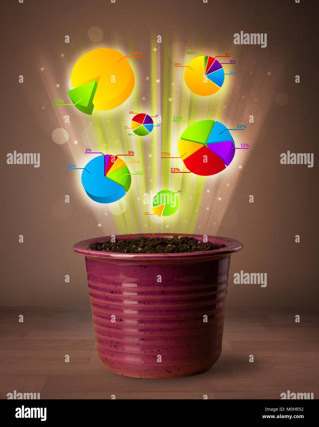 Glowing pie charts coming out from flowerpot Stock Photo - Alamy