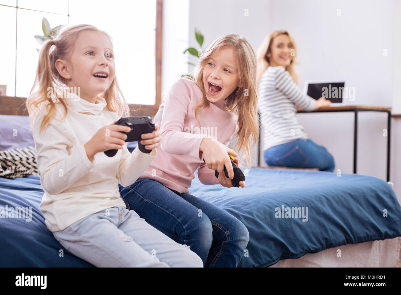 Inspired young girls playing a game Stock Photo - Alamy