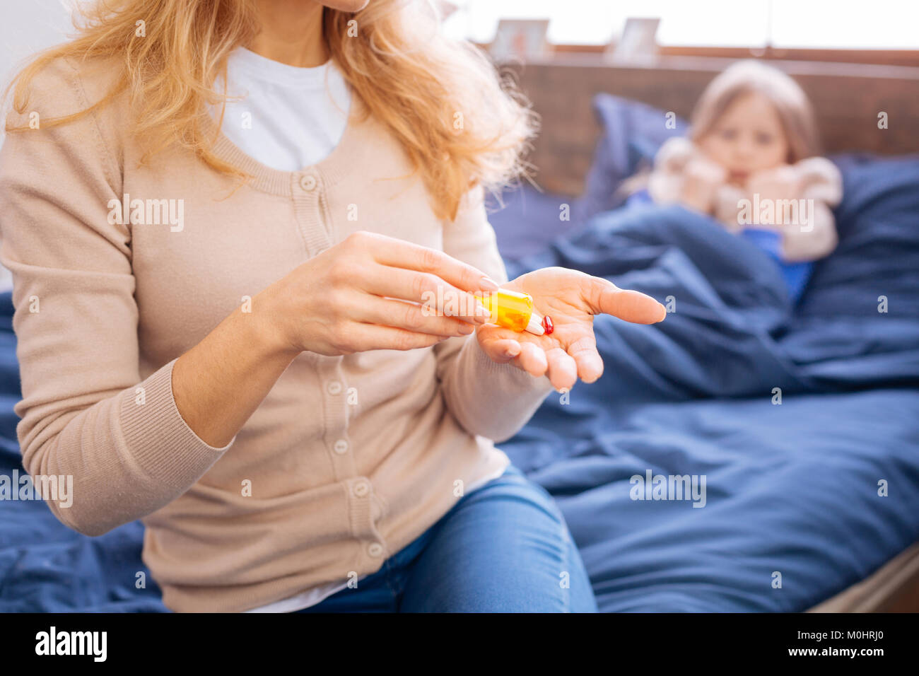 Mother holding medication prescribed to her child Stock Photo - Alamy