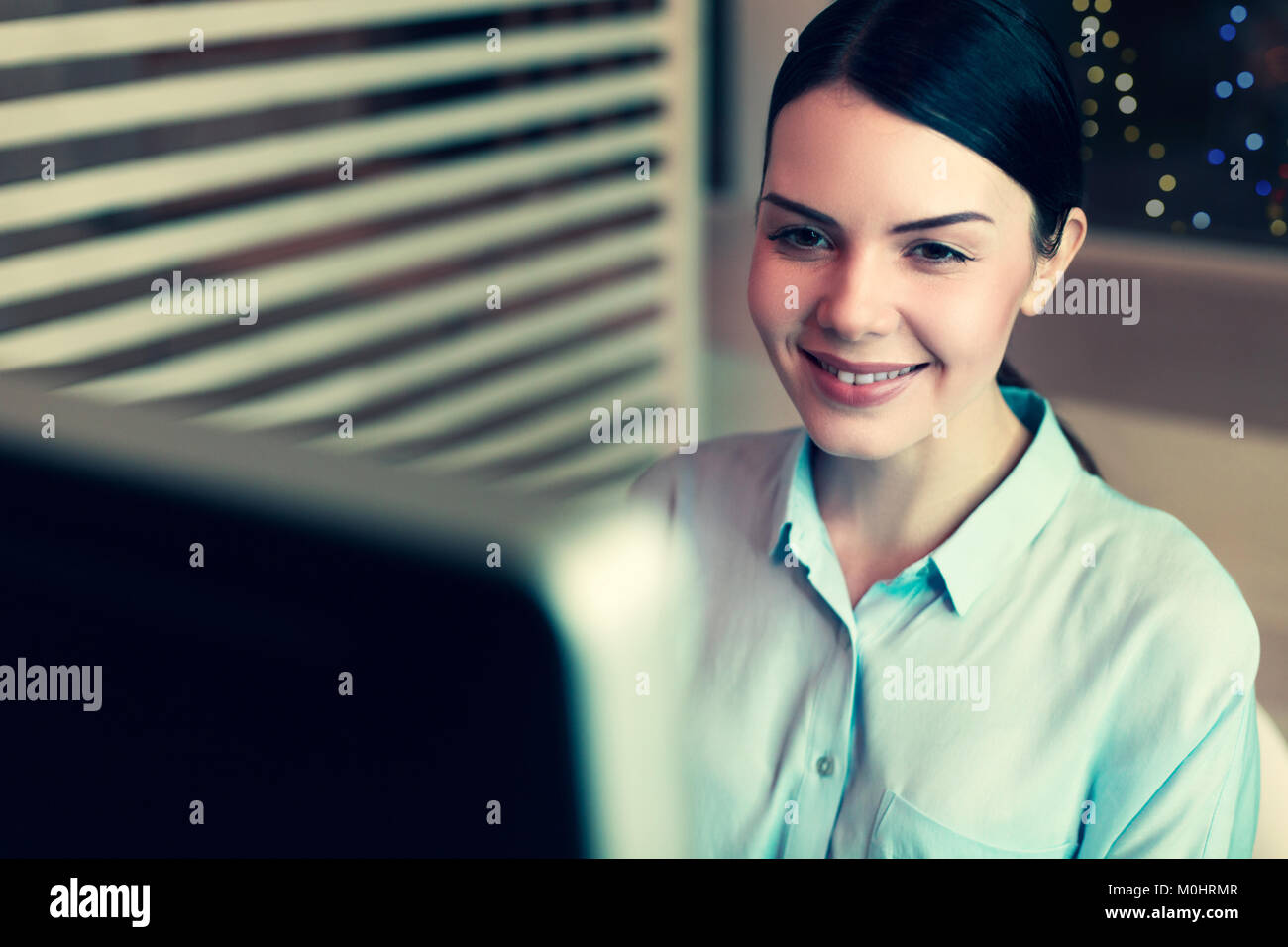 Pretty woman working on computer in the office Stock Photo - Alamy