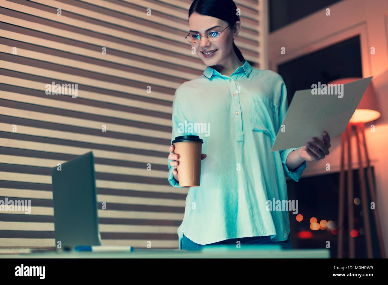 Gorgeous woman checking data on her laptop Stock Photo - Alamy