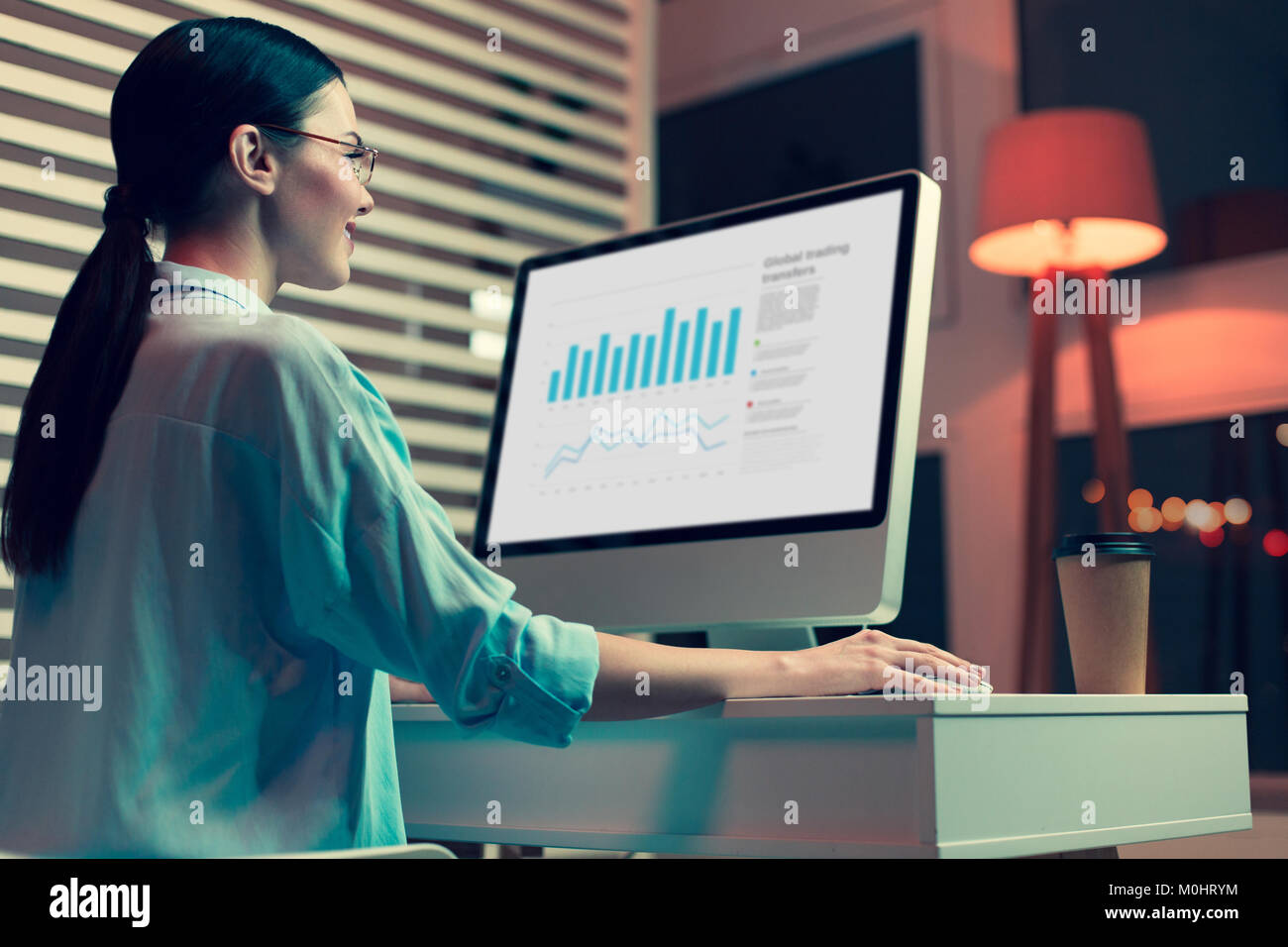 Smiling female analyst creating graphs and diagrams Stock Photo - Alamy