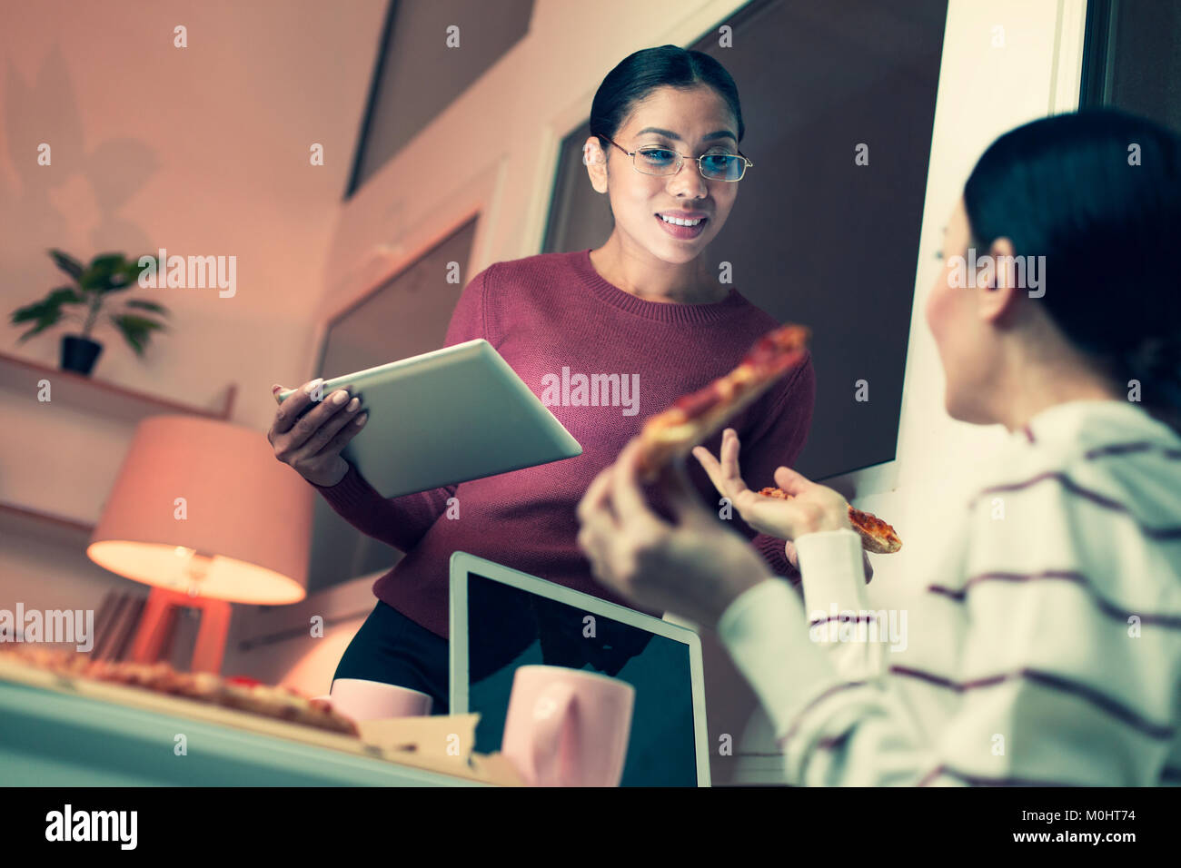Pretty women discussing gossips during lunch break Stock Photo - Alamy