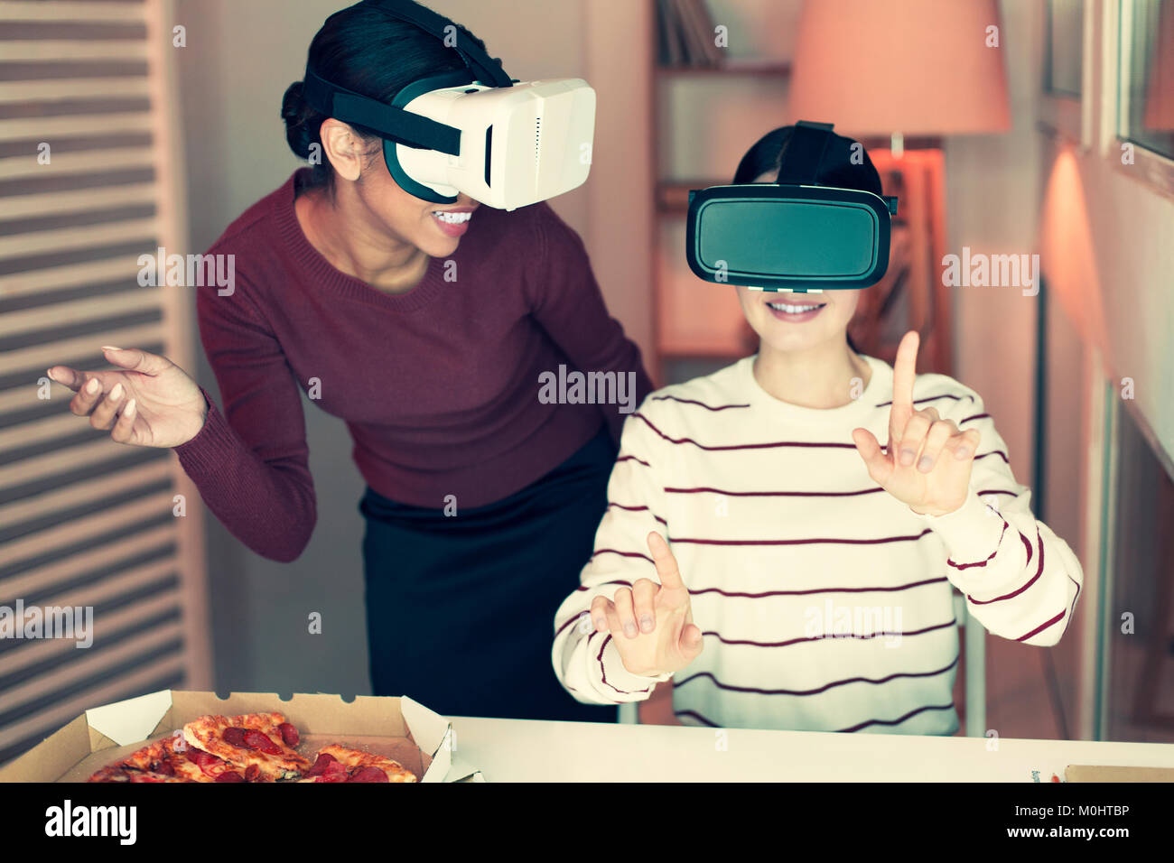 Cheerful best friends playing in virtual reality Stock Photo - Alamy
