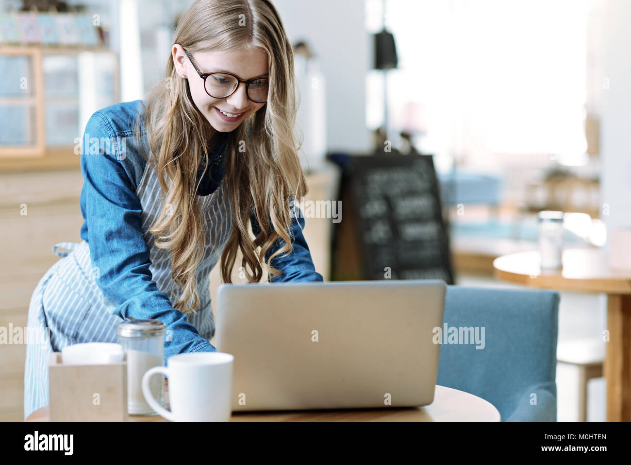 Positive delighted female that using computer Stock Photo - Alamy