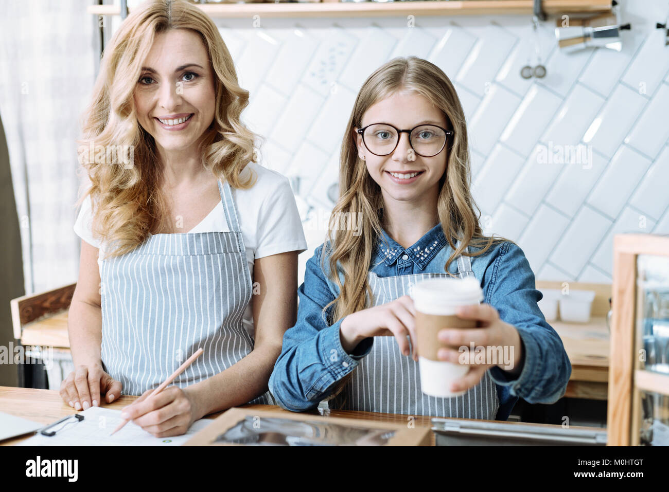 Cheerful mother being glad while working Stock Photo - Alamy