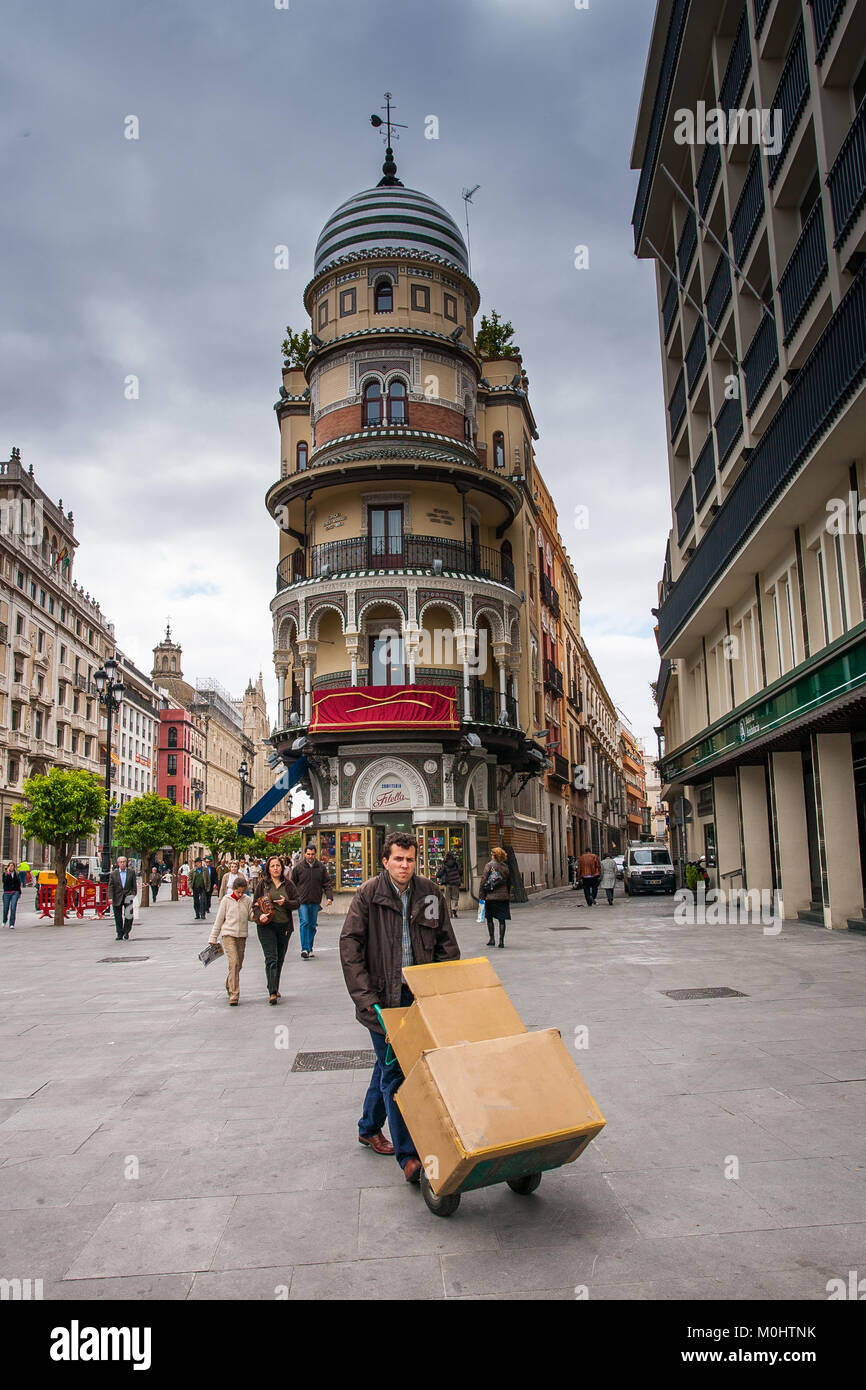 Seville, Andalusia, Spain - unknown man carries a parcel among the ...