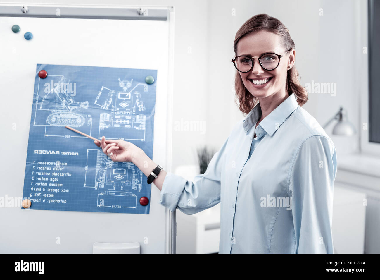 Confident engineer presenting her project Stock Photo - Alamy