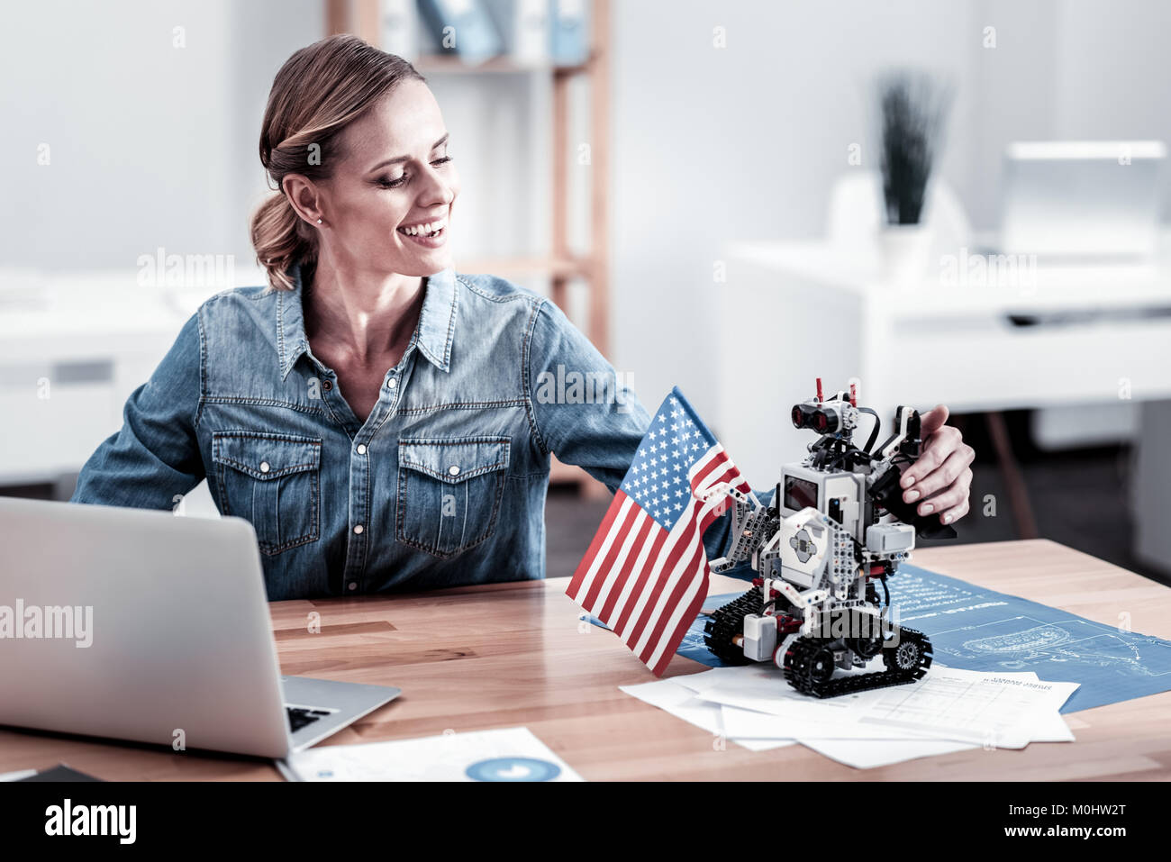 Joyful girl playing with her robot Stock Photo - Alamy
