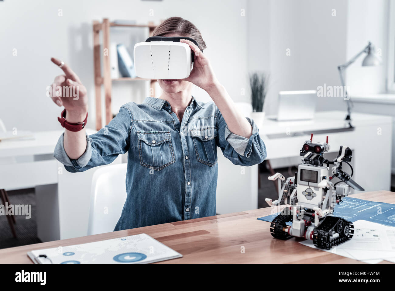 Concentrated engineer examining technological mask Stock Photo - Alamy