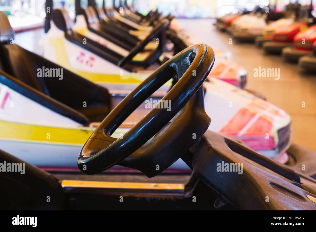 closeup of some bumper cars parked in the track, in an amusement park ...