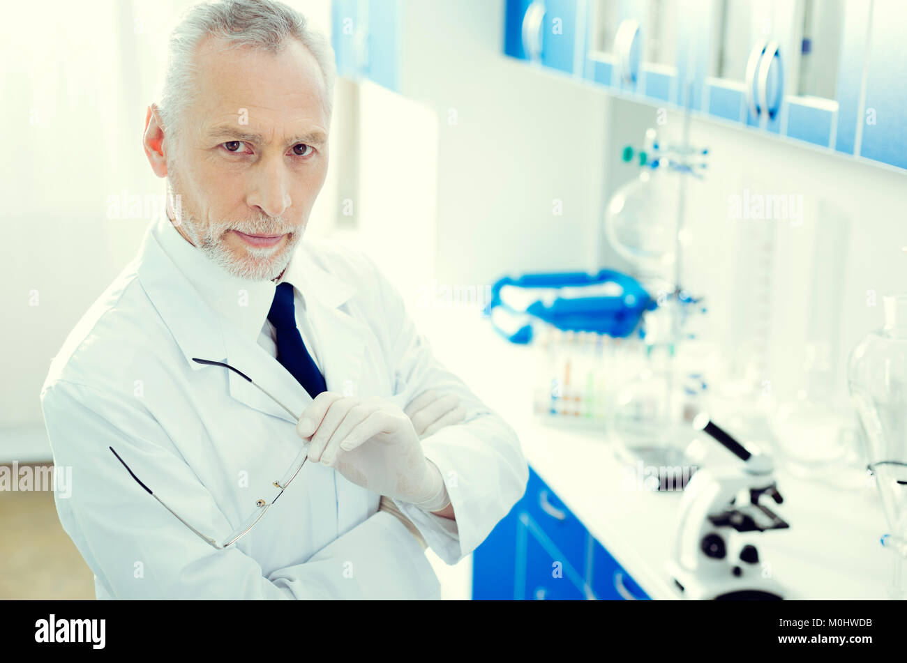 Serious mature researcher posing and looking into camera Stock Photo ...