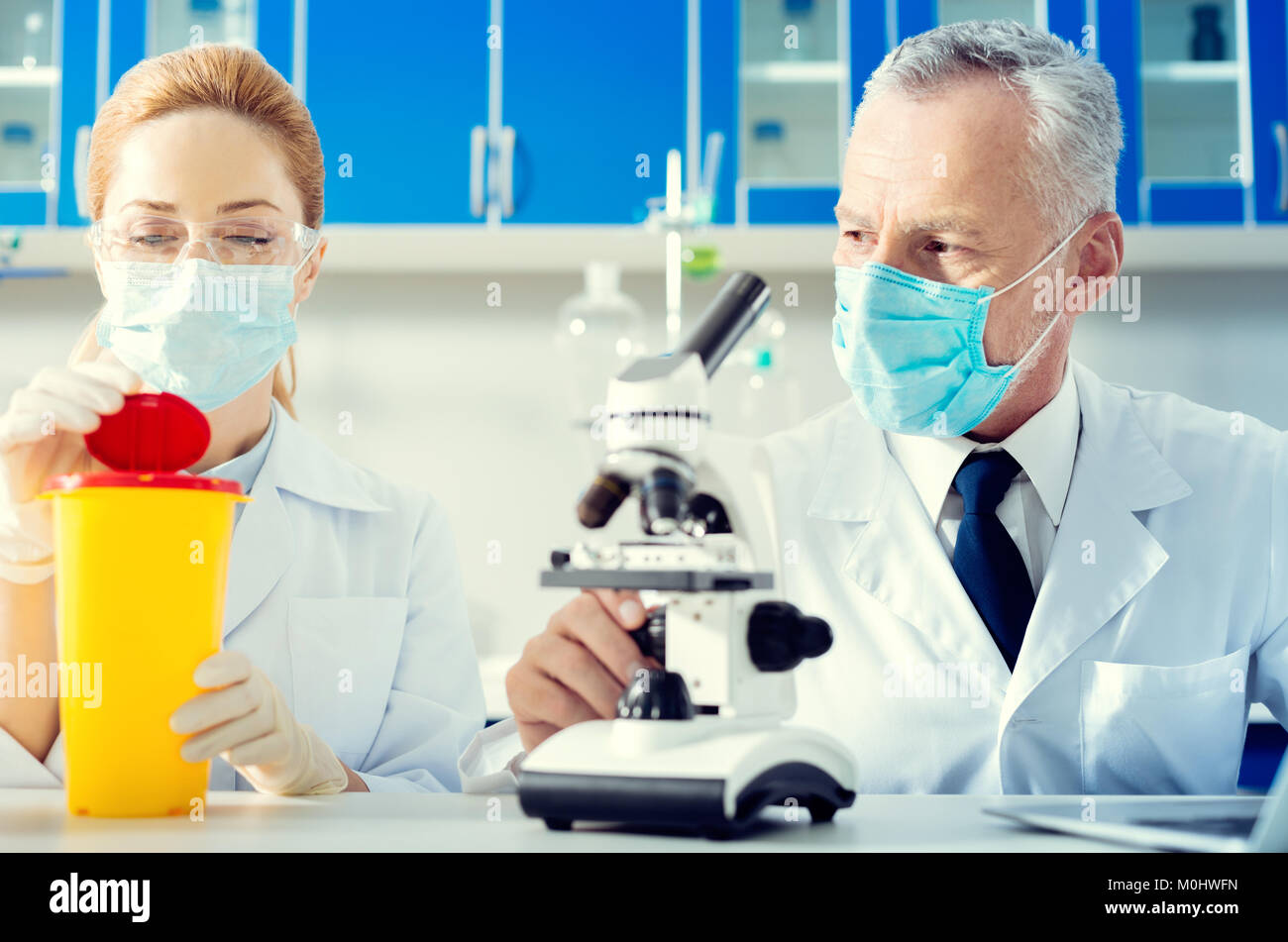 Lab colleagues conducting scientific experiment Stock Photo - Alamy