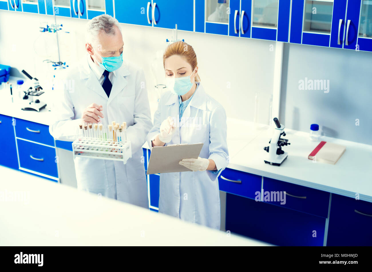 Researcher writing down results of their experiment Stock Photo - Alamy