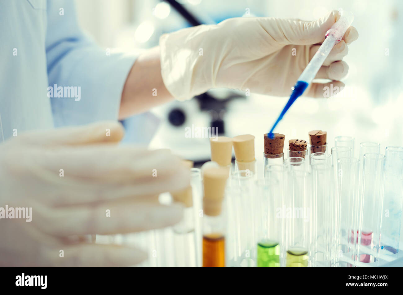 Lab worker using pipette while working with liquids Stock Photo - Alamy