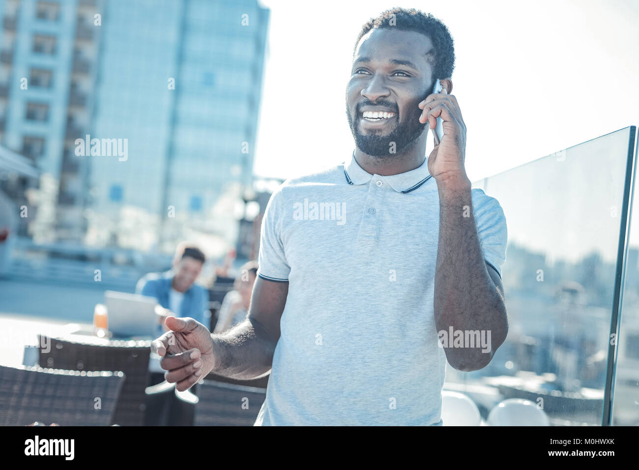 Radiant young man enjoying phone conversation Stock Photo - Alamy Radiant young man enjoying phone conversation Stock Photo - Alamy