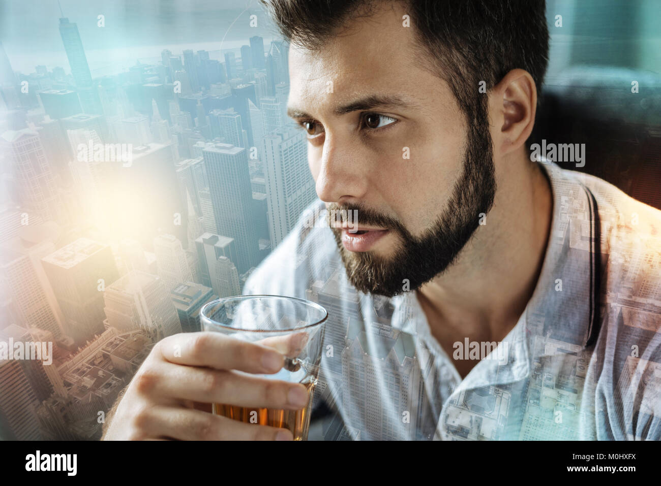 Thoughtful man looking into the distance while drinking alcohol Stock ...