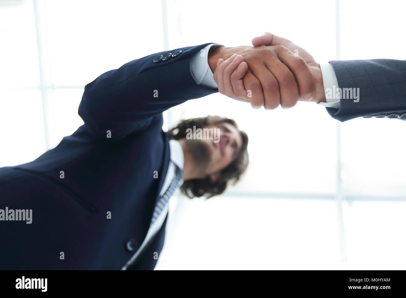 bottom view of two men shaking hands while standing Stock Photo - Alamy