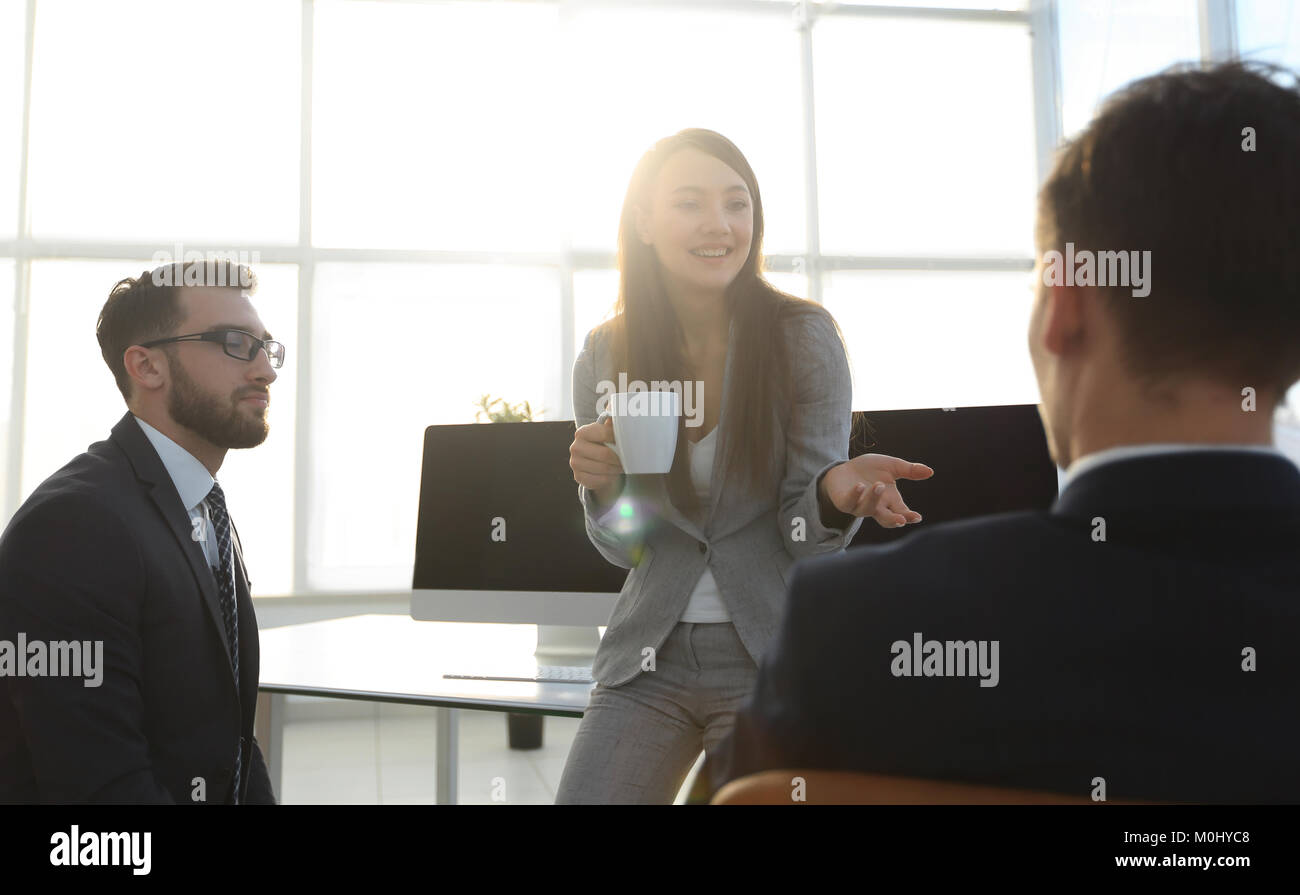colleagues chatting while enjoying coffee break in the office Stock ...