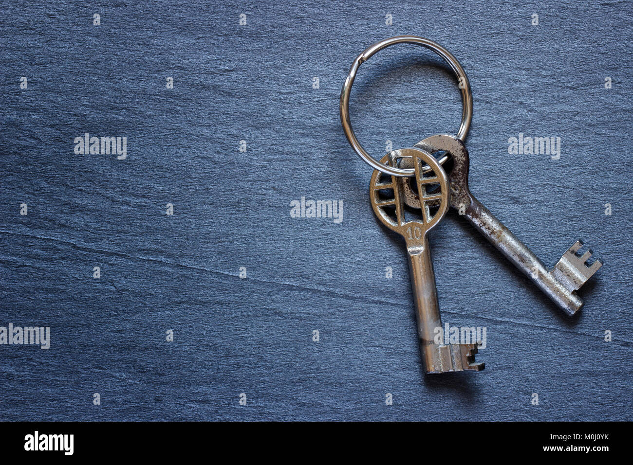 Set of old keys on slate background Stock Photo - Alamy