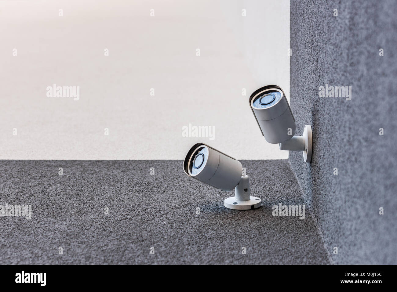 bottom view of two security cameras on office building, security system ...