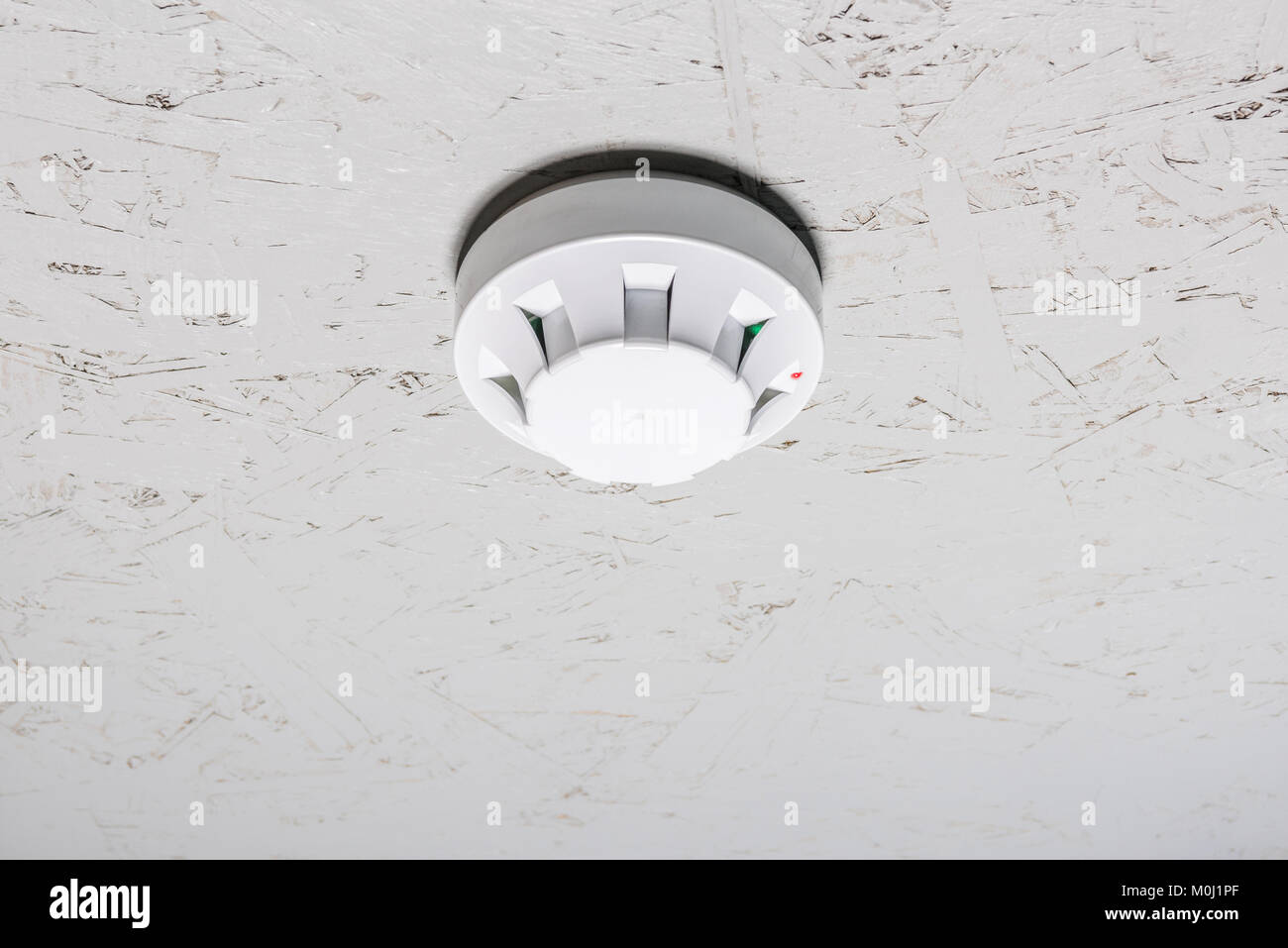 smoke detector of fire alarm on white ceiling at home Stock Photo - Alamy