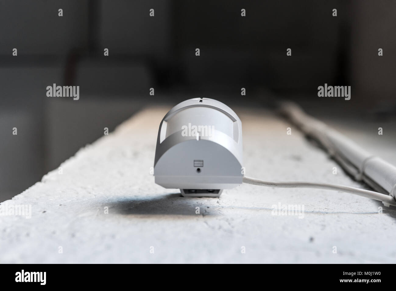 bottom view of one motion sensor on white wall Stock Photo - Alamy