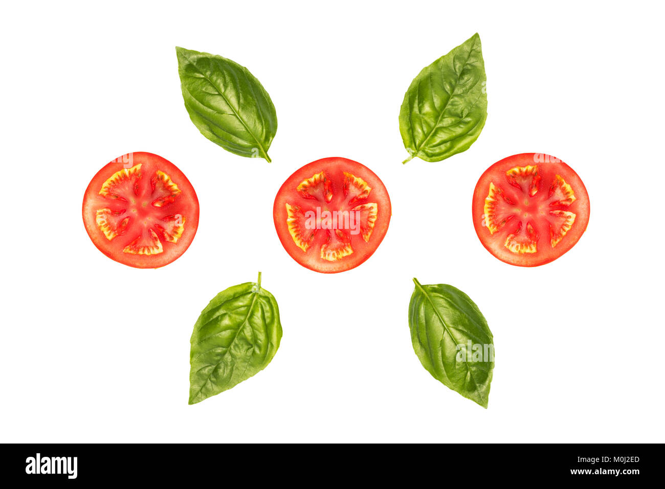 composition of tomato slices with basil leaves Stock Photo - Alamy