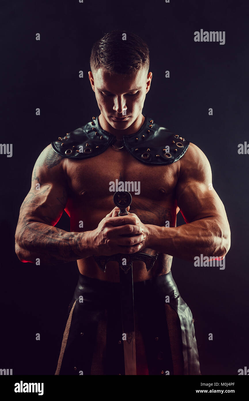 Portrait handsome muscular gladiator sword hi-res stock photography and ...