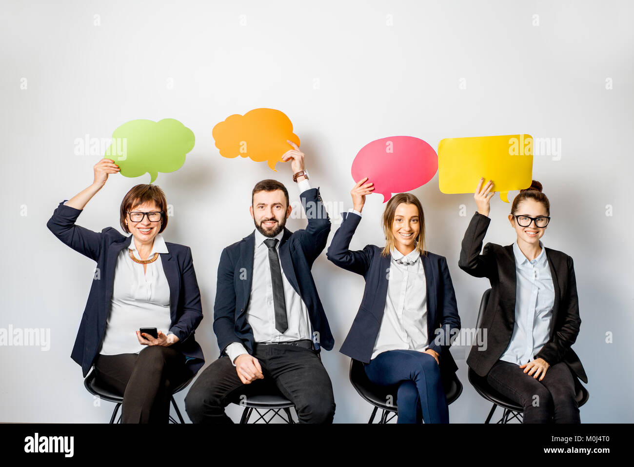 Business people holding colorful bubbles Stock Photo - Alamy