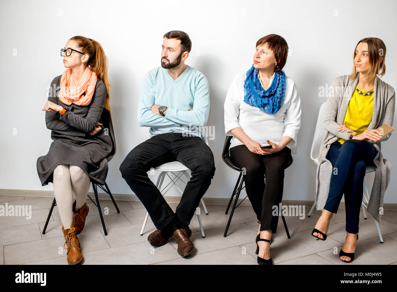 People in casual sitting in a row Stock Photo - Alamy