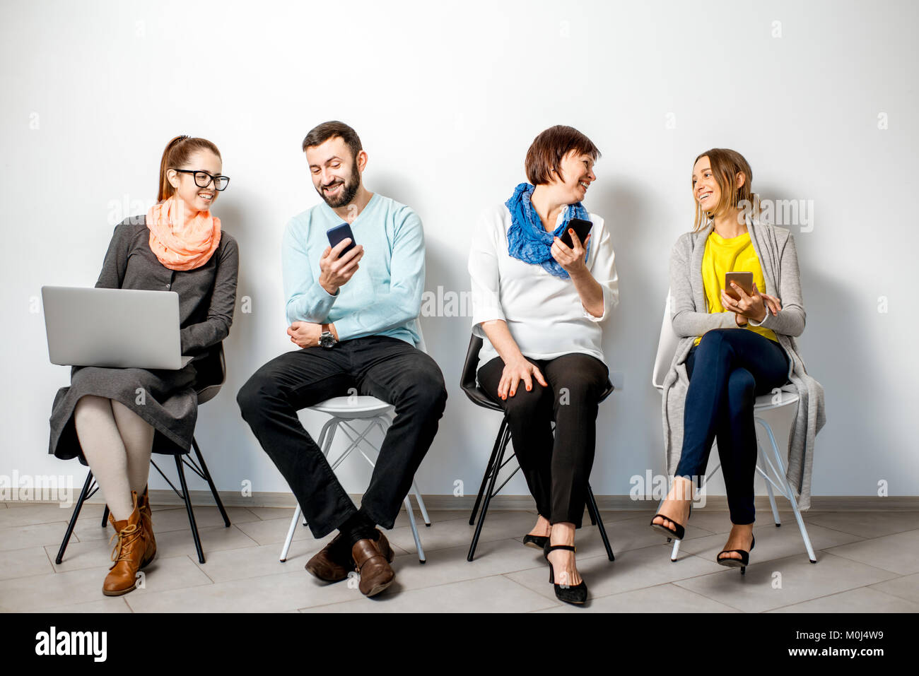 People with gadgets on the white background Stock Photo - Alamy