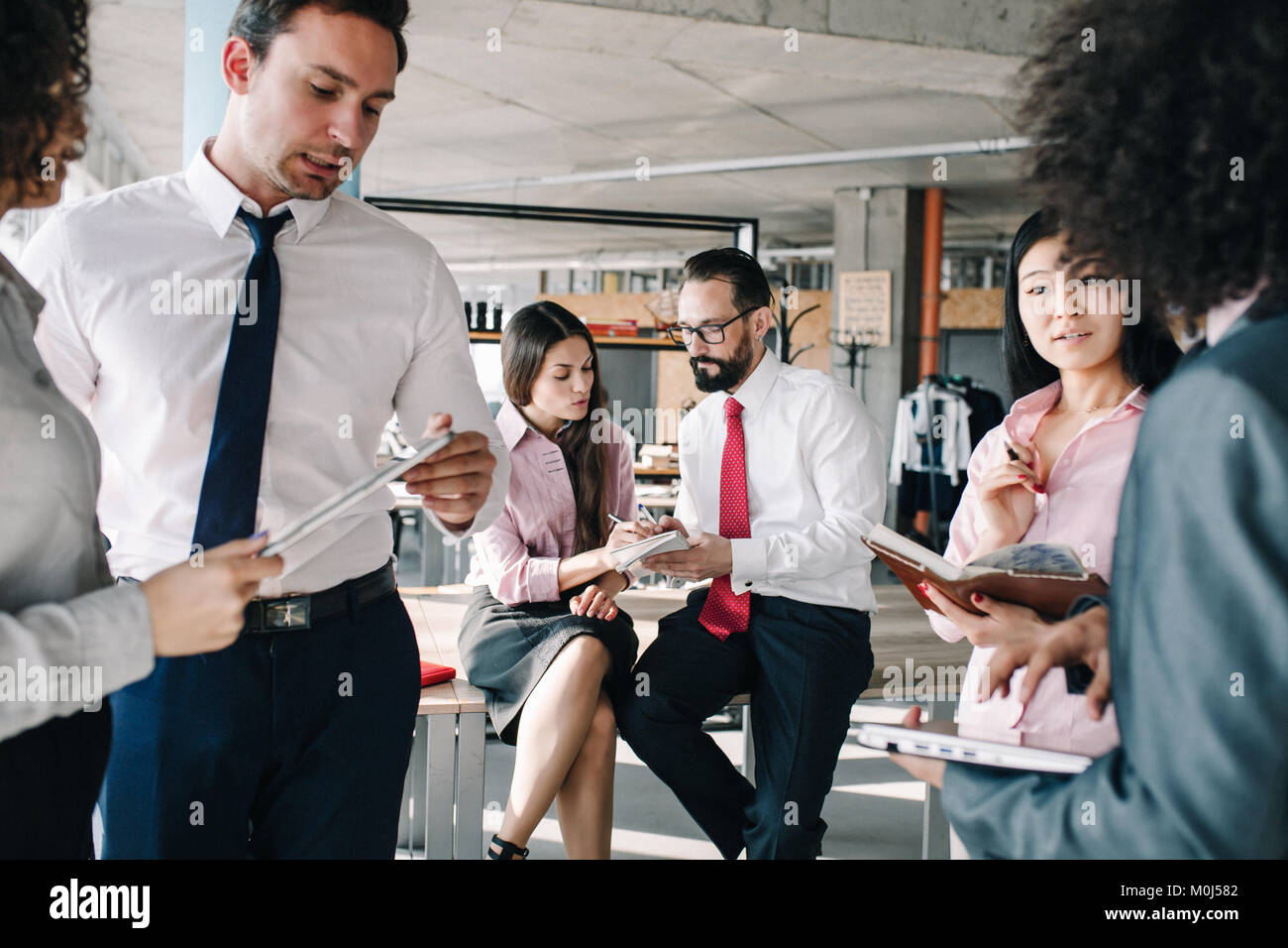 Young team of coworkers making great meeting discussion Stock Photo - Alamy