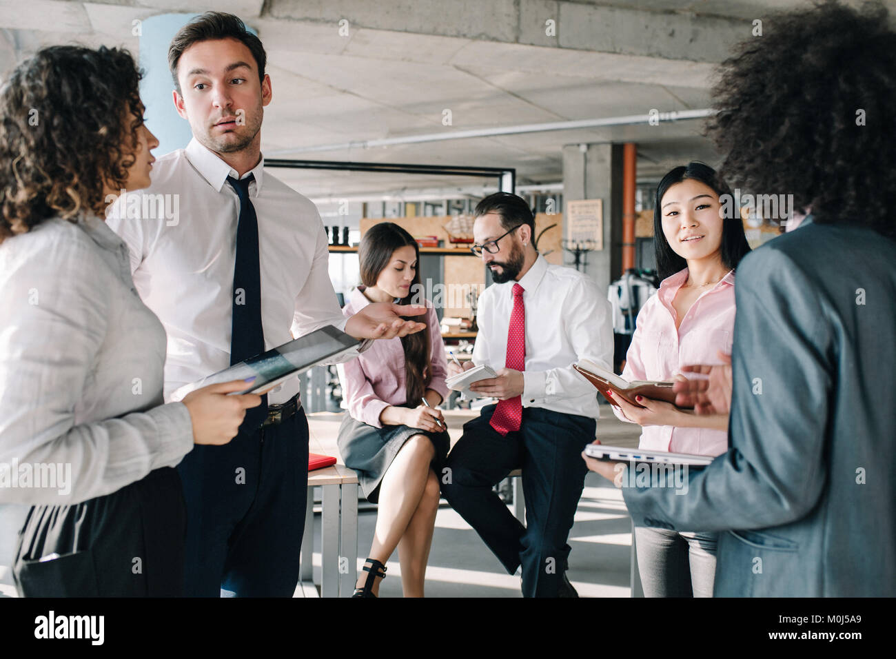 Young team of coworkers making great meeting discussion Stock Photo - Alamy