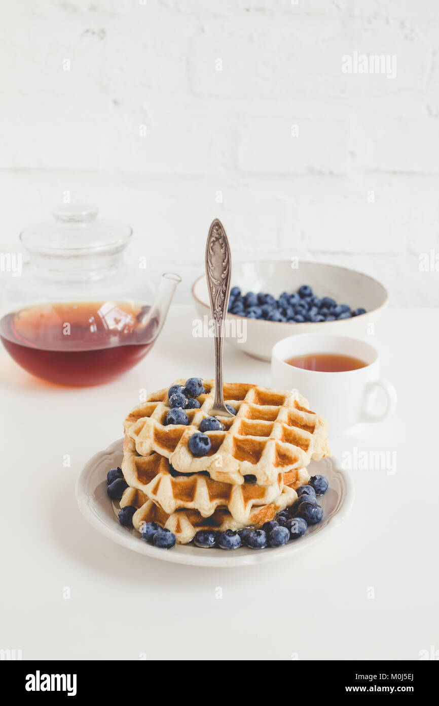 tasty breakfast of waffles with blueberries and tea Stock Photo - Alamy