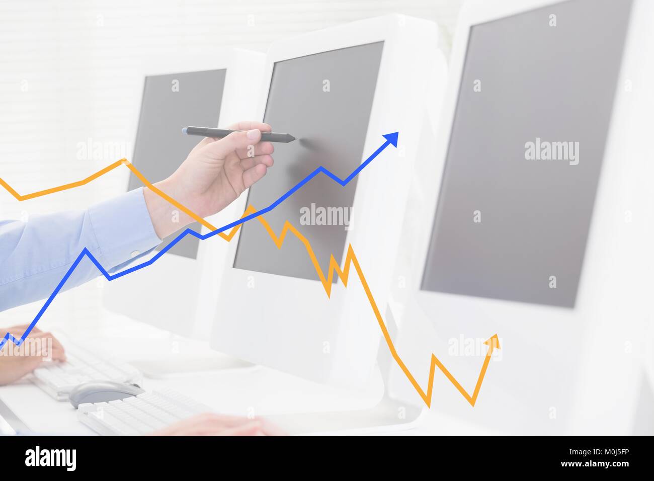 Hand using computer with graph overlays Stock Photo - Alamy