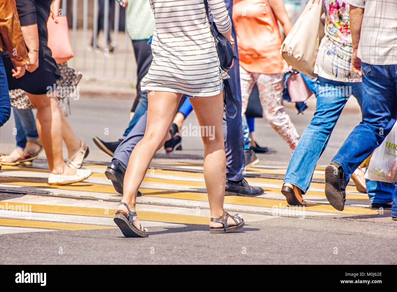crossroad with walking pedestrians on summer day Stock Photo - Alamy