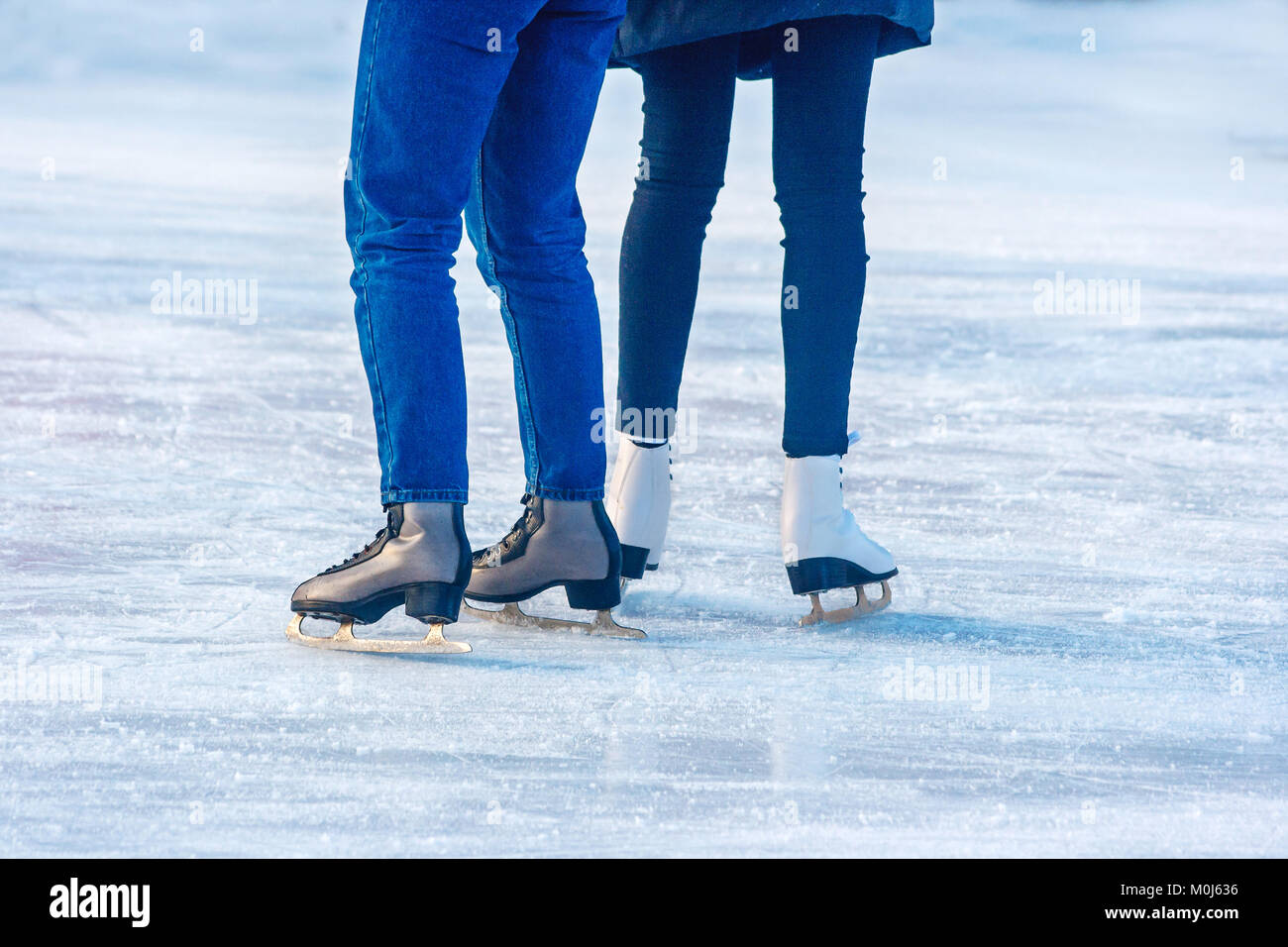 two young girls are skating on the rink. feet closeup Stock Photo - Alamy