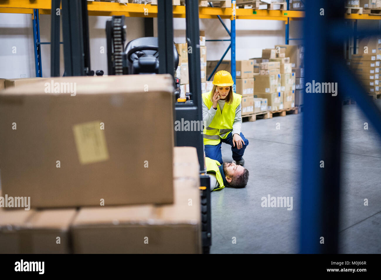 Warehouse workers after an accident in a warehouse Stock Photo - Alamy
