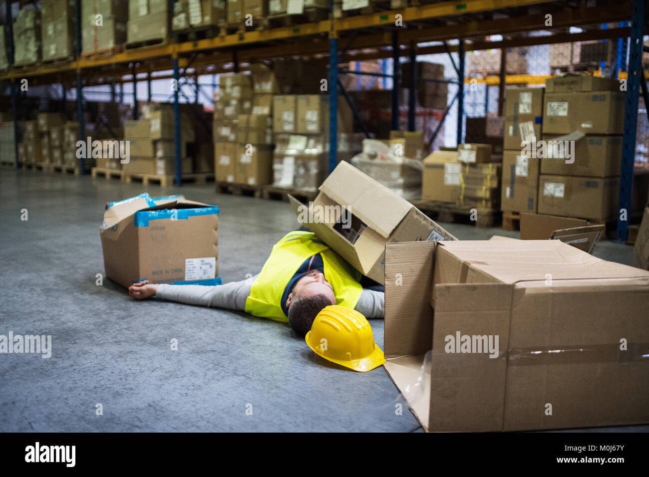 Warehouse worker after an accident in a warehouse Stock Photo - Alamy