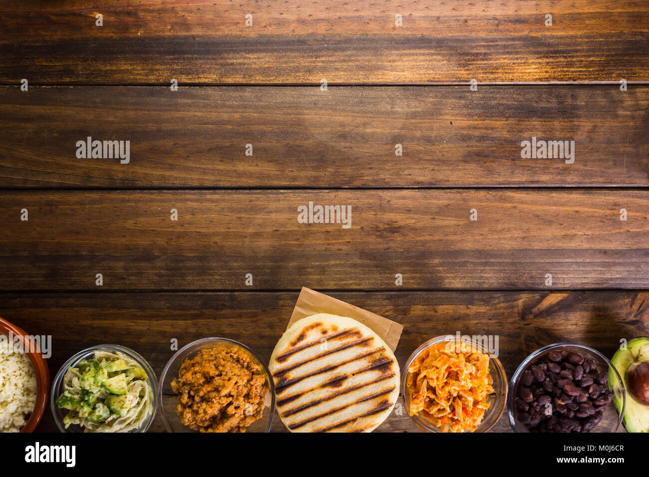 Three types of arepas, Latin American food on wood table Stock Photo ...