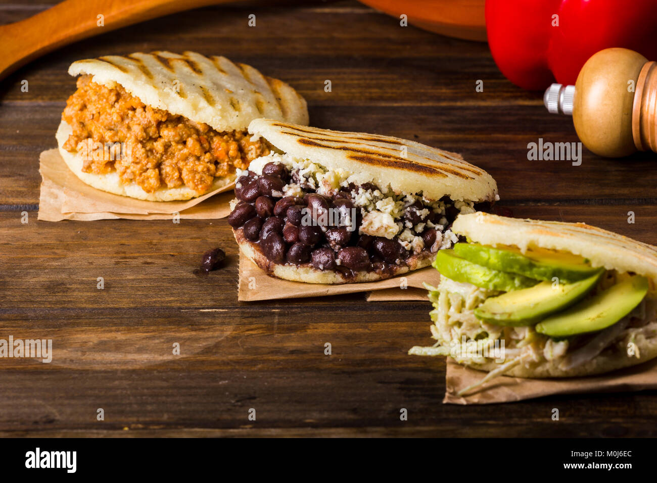Three types of arepas, Latin American food on wood table Stock Photo ...