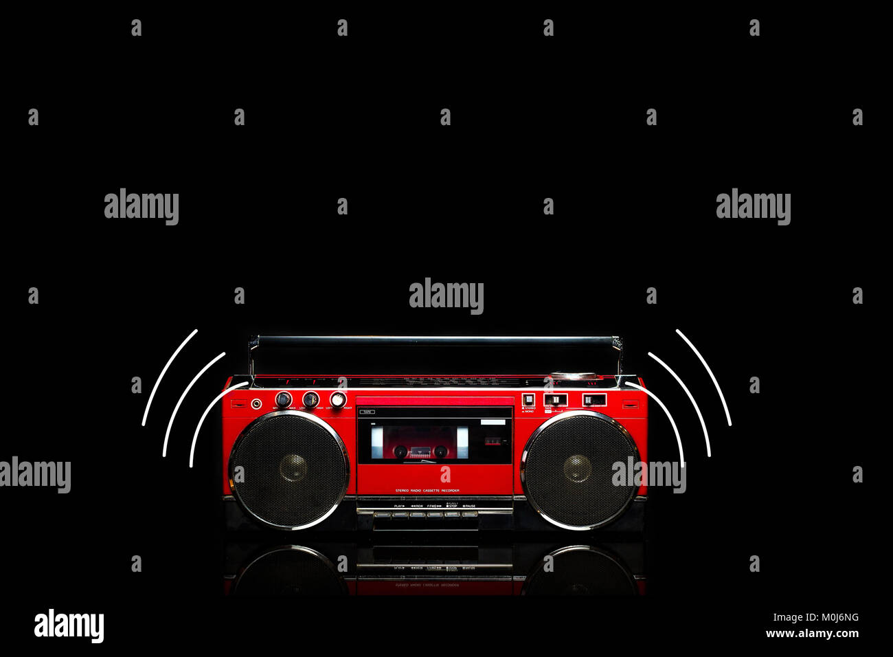 Red boom box on black background Stock Photo - Alamy
