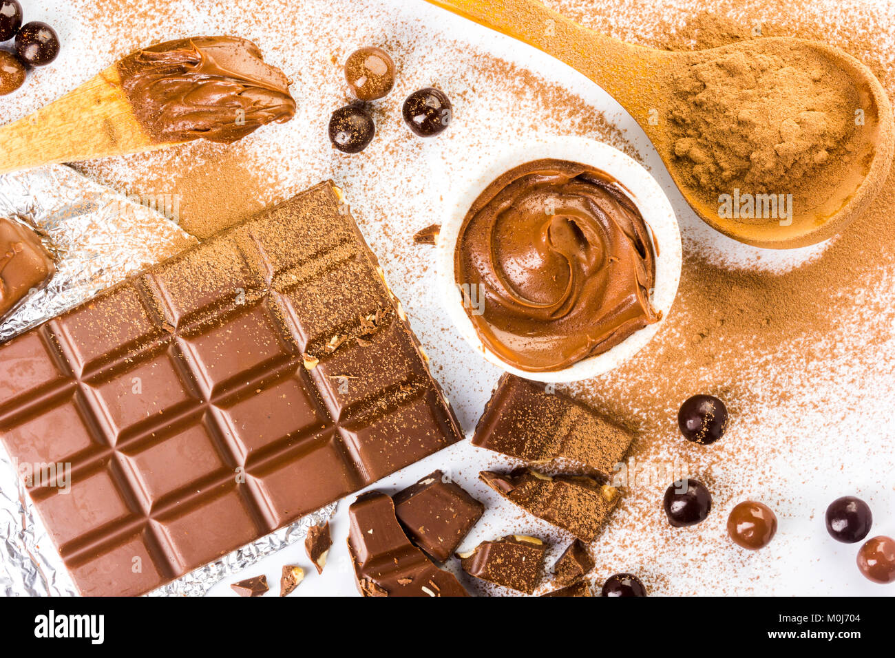 frame with different types of chocolate, powder, cream and bar on a ...