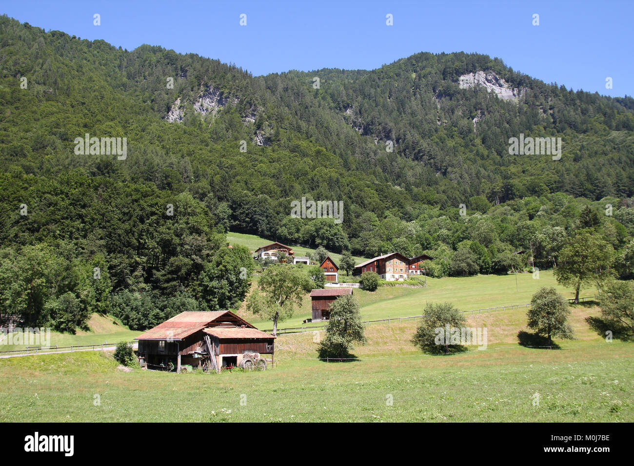 Switzerland - beautiful alpine village. Small town with green pastures ...
