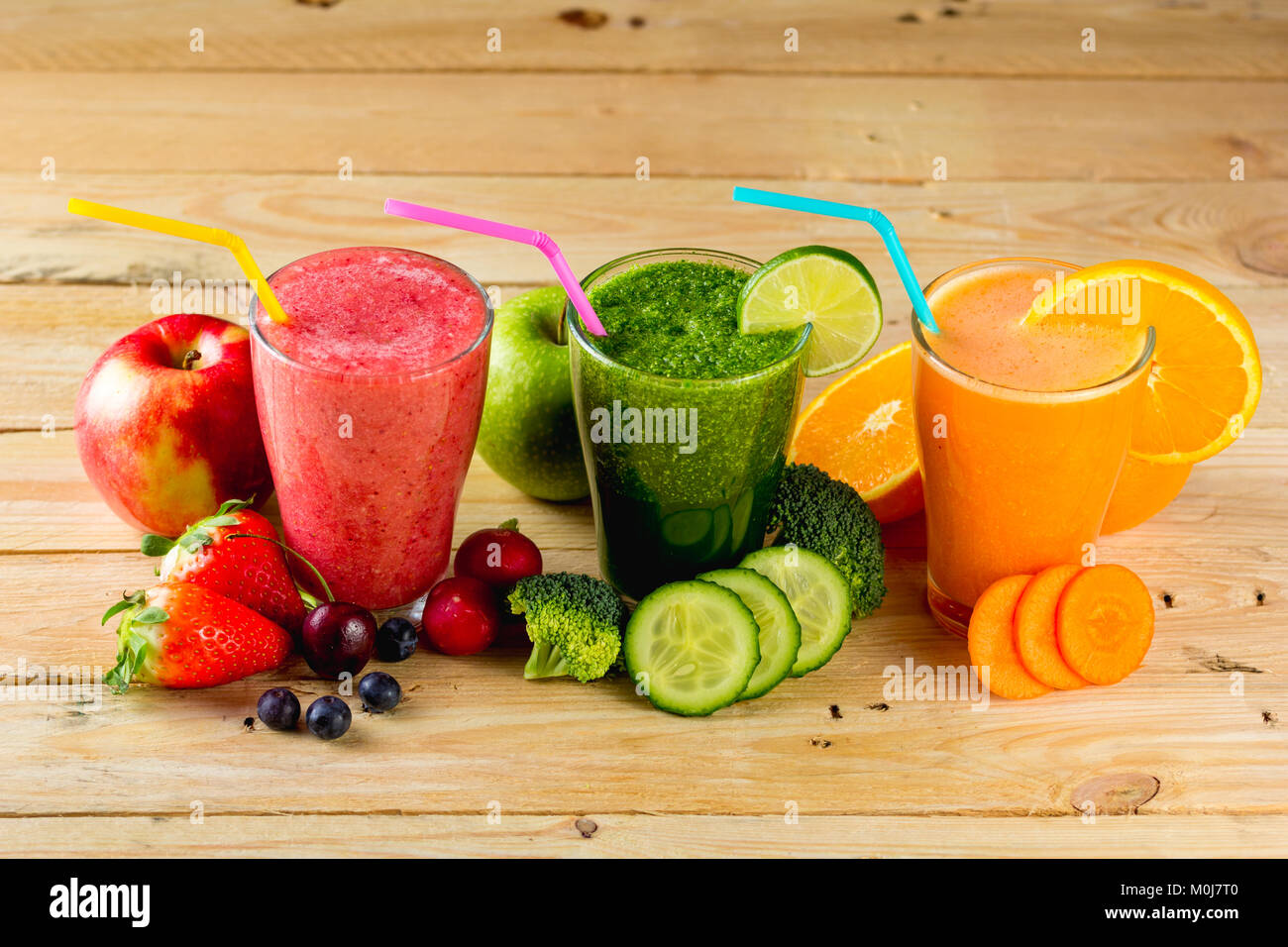 Blended fruit smoothies on wood table Stock Photo - Alamy