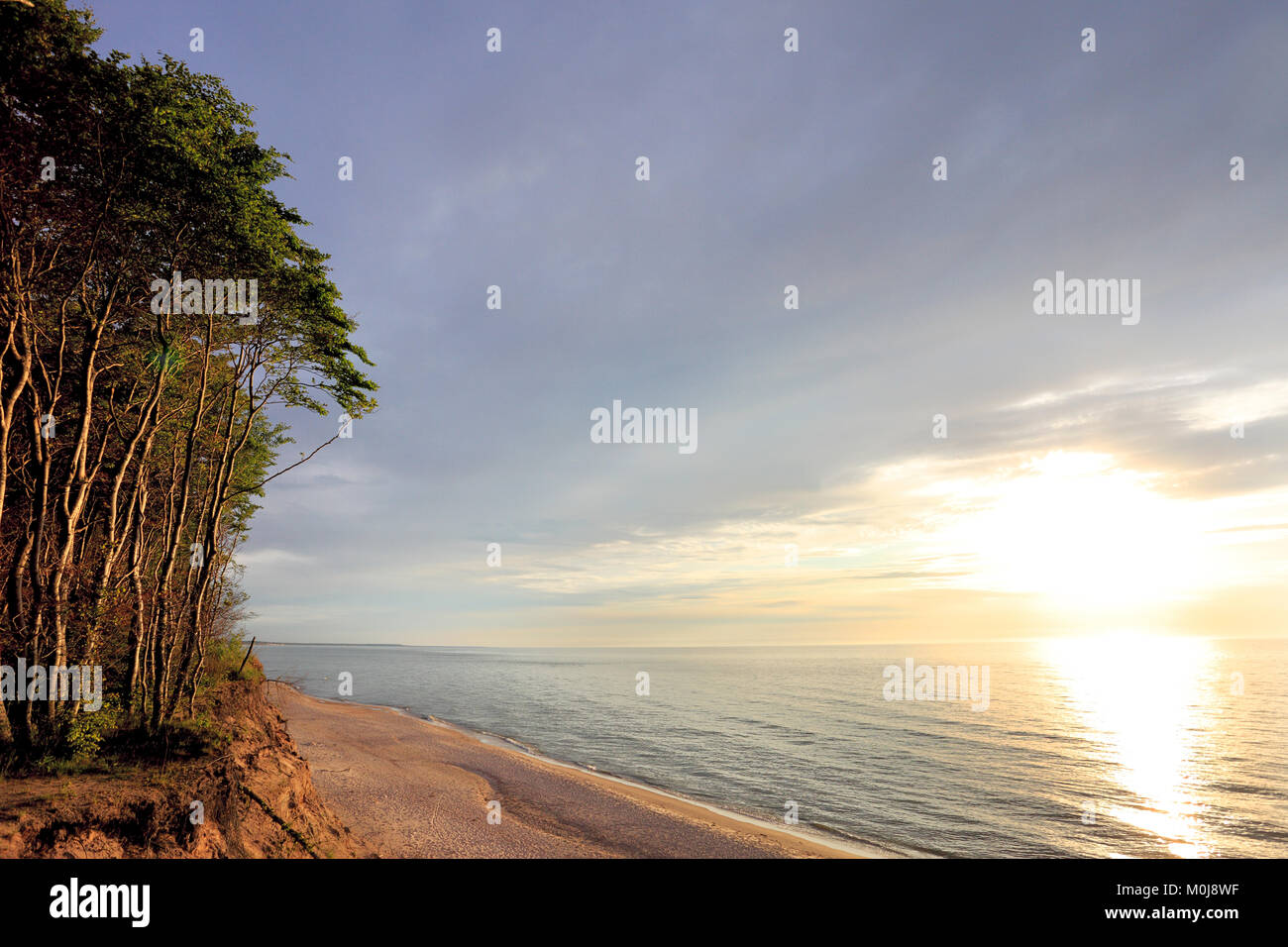 Baltic Sea shore and beach during colorful sunset in Rowy, Pomerania ...