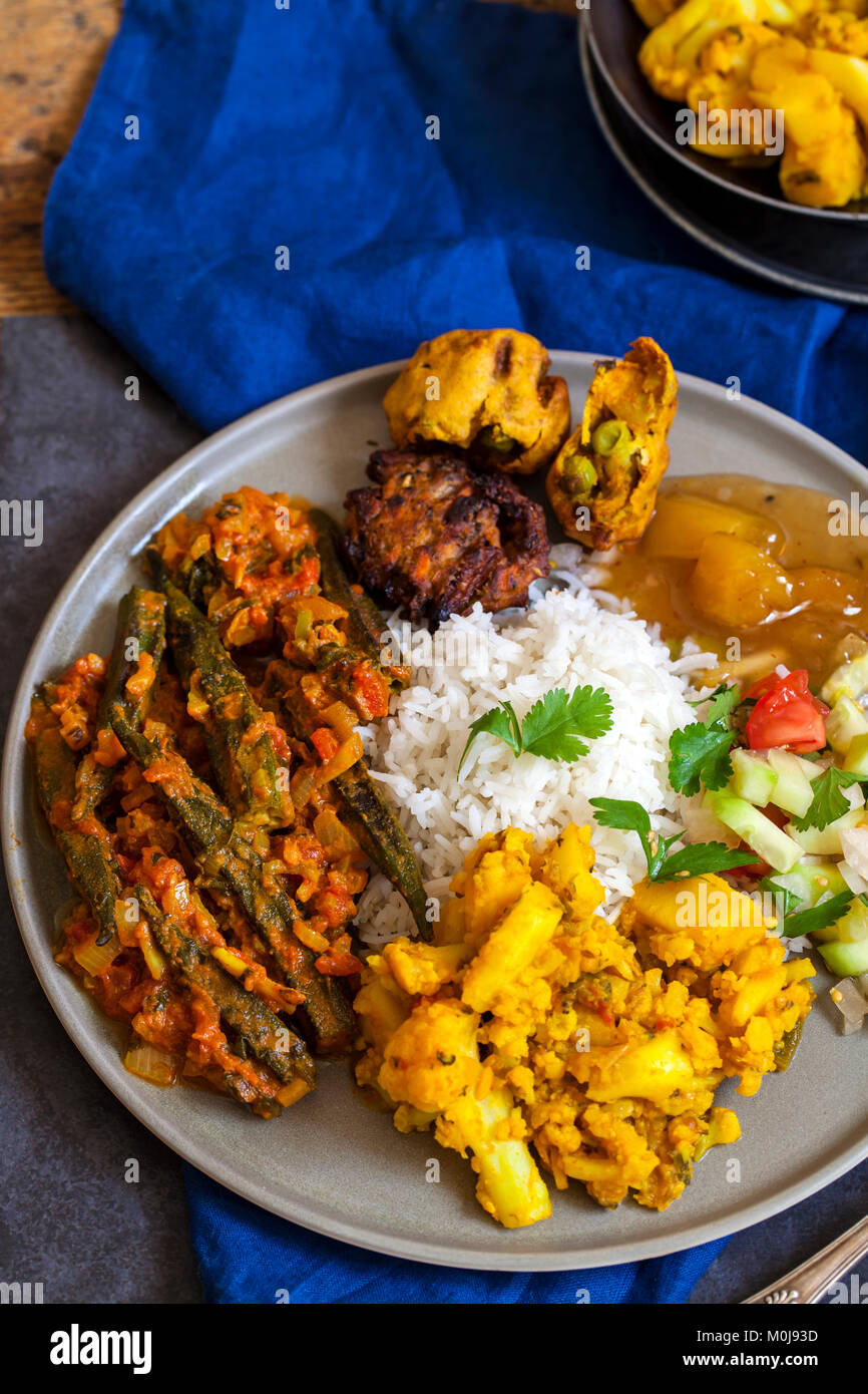 Indian meal with aloo gobi, okra curry, rice and pakoras Stock Photo ...