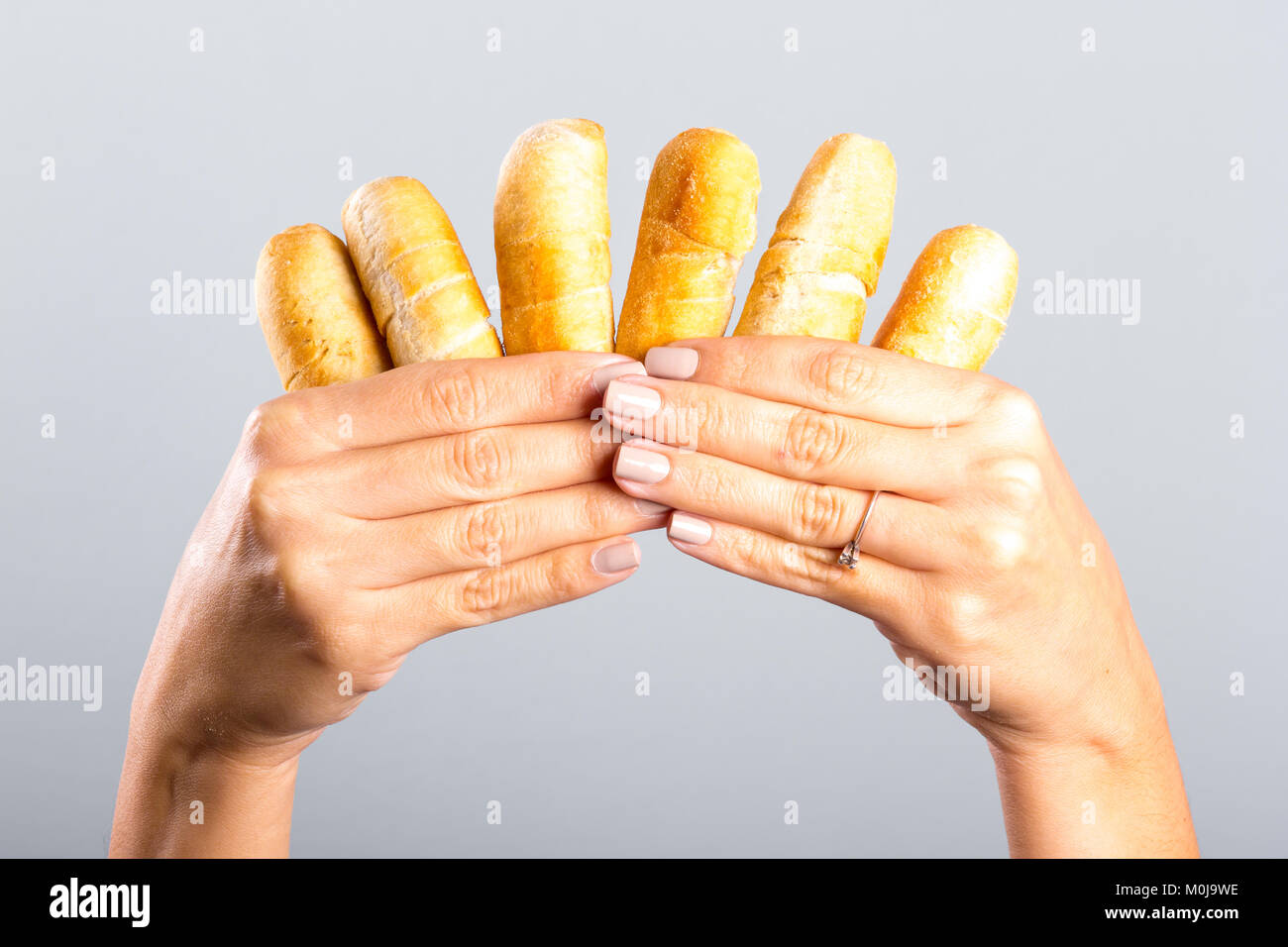woman's hand holding cheese fingers Stock Photo - Alamy