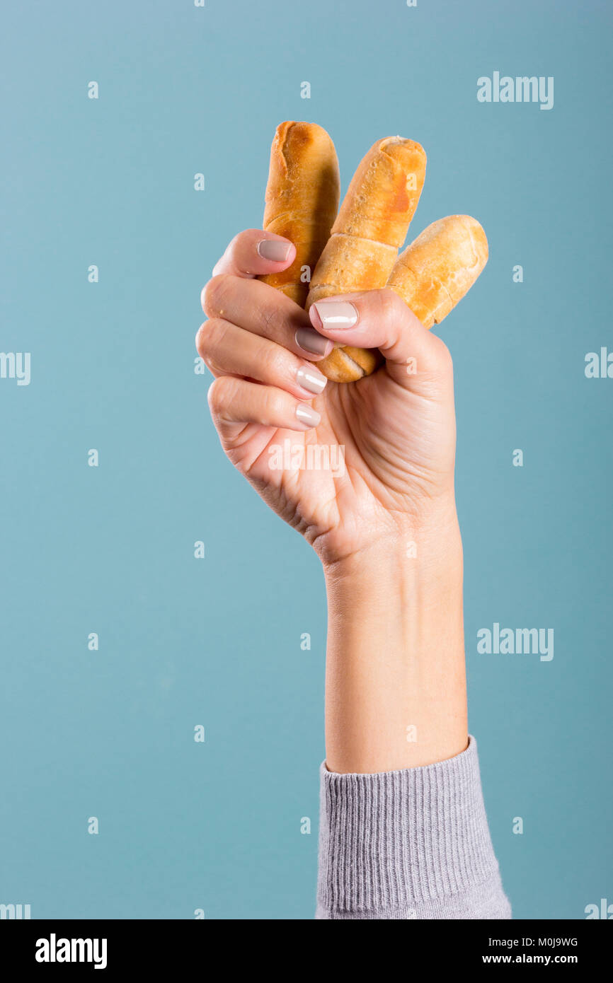 woman's hand holding cheese fingers Stock Photo - Alamy
